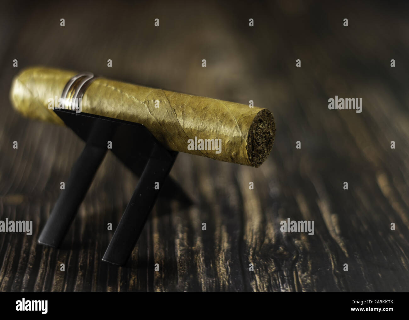 Cigar with the holder on the wood table Stock Photo - Alamy