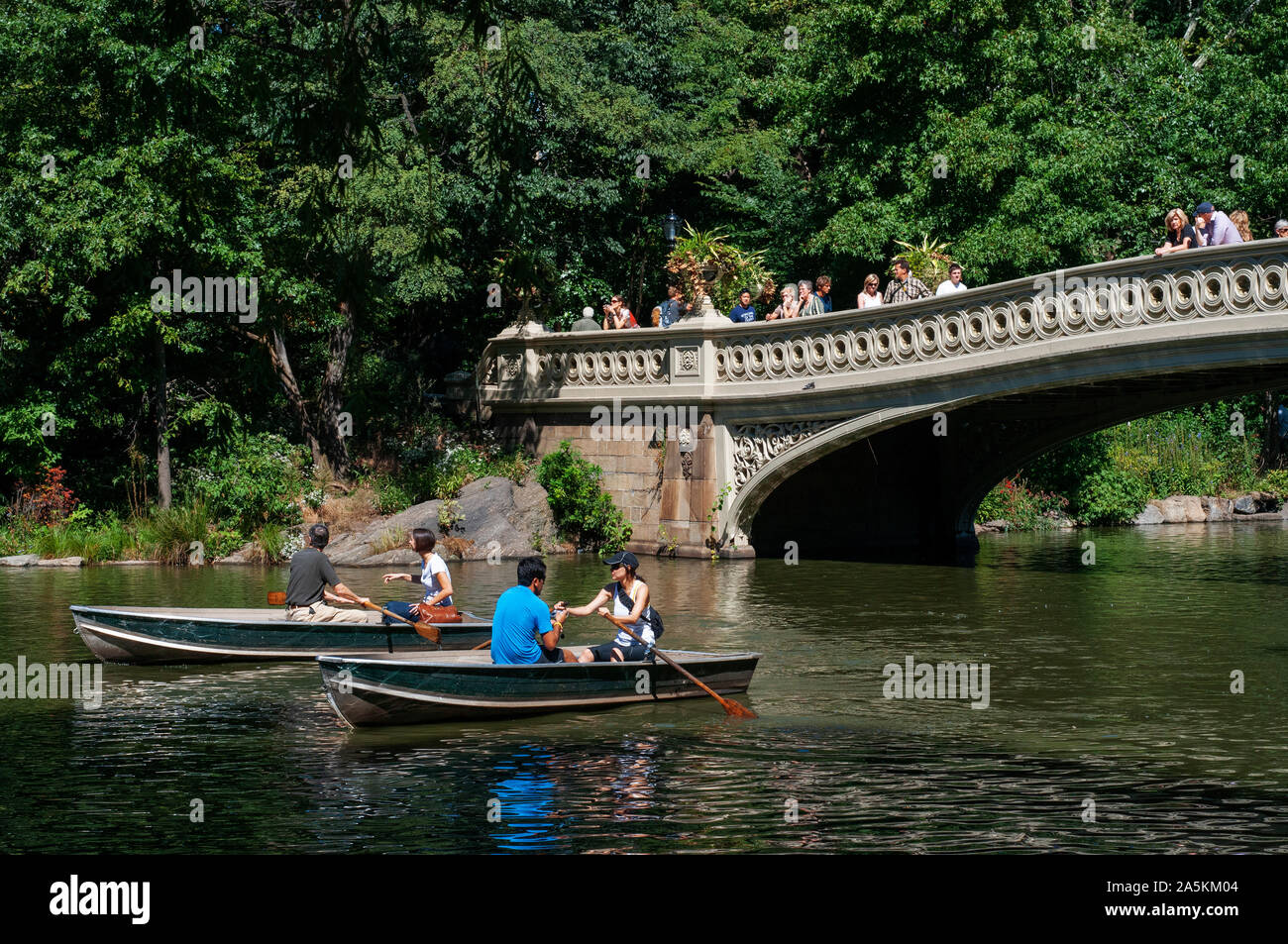 Young couple in rowing boat on lake in Central Park, New York City, USA ...
