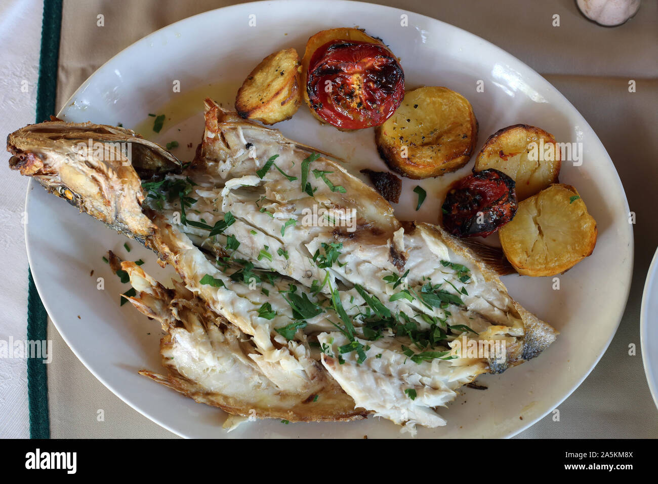 Dinner in Cyprus including grilled sea bass (entire fish), potatoes and ...