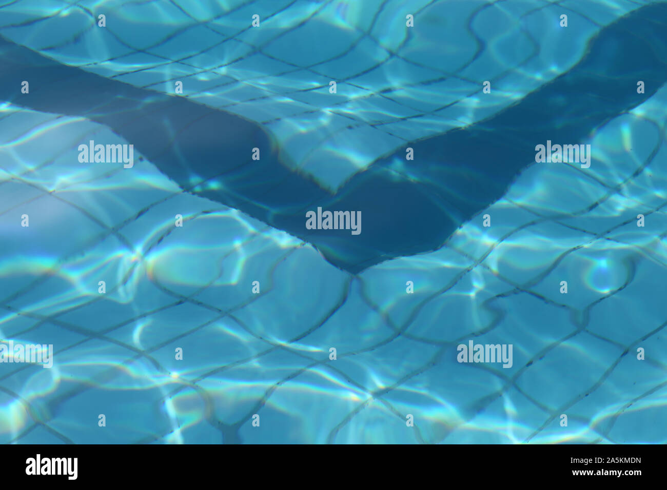 Bottom of a swimming pool with beautiful turquoise water and darker ...