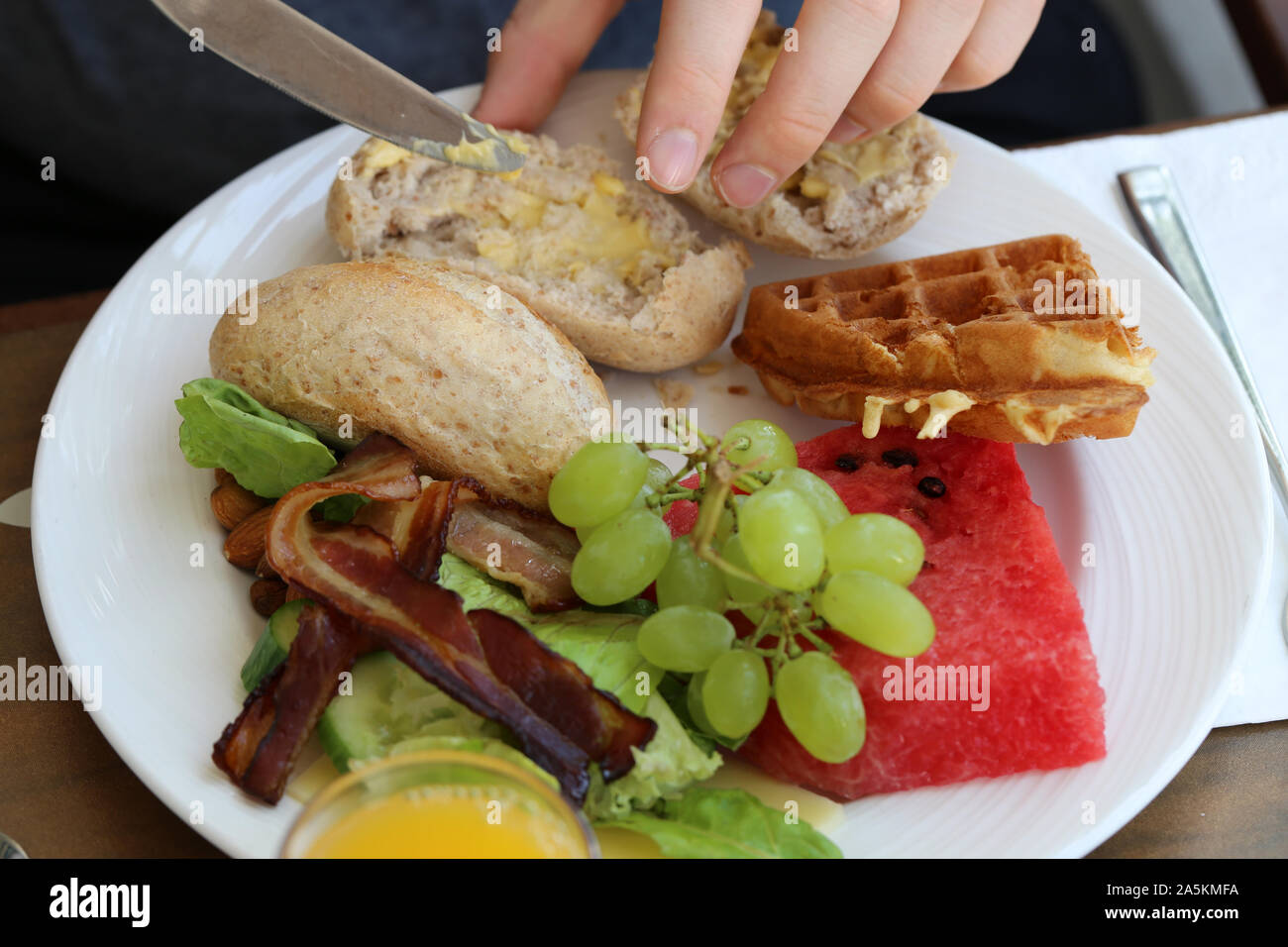 Plate of healthy breakfast items including fruit like melon and grapes ...
