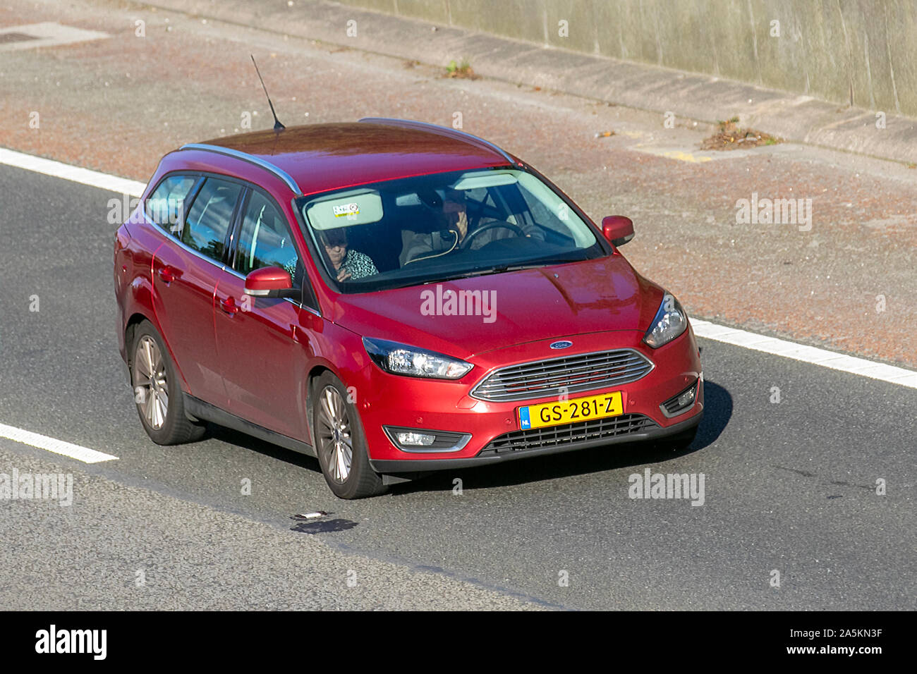 Red Ford Focus saloon; UK Vehicular traffic, transport, modern, saloon ...