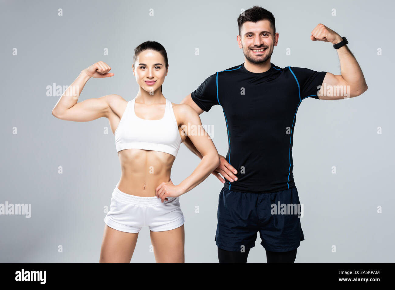 Beautiful athletic couple on gray background isolated with clipping ...