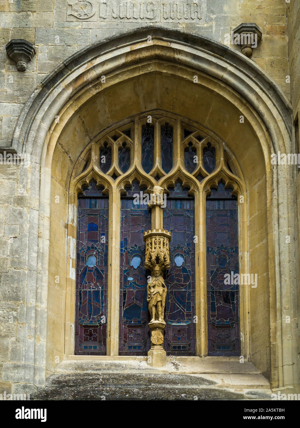 Exterior stone arch window with stained glass on west front of Bath ...