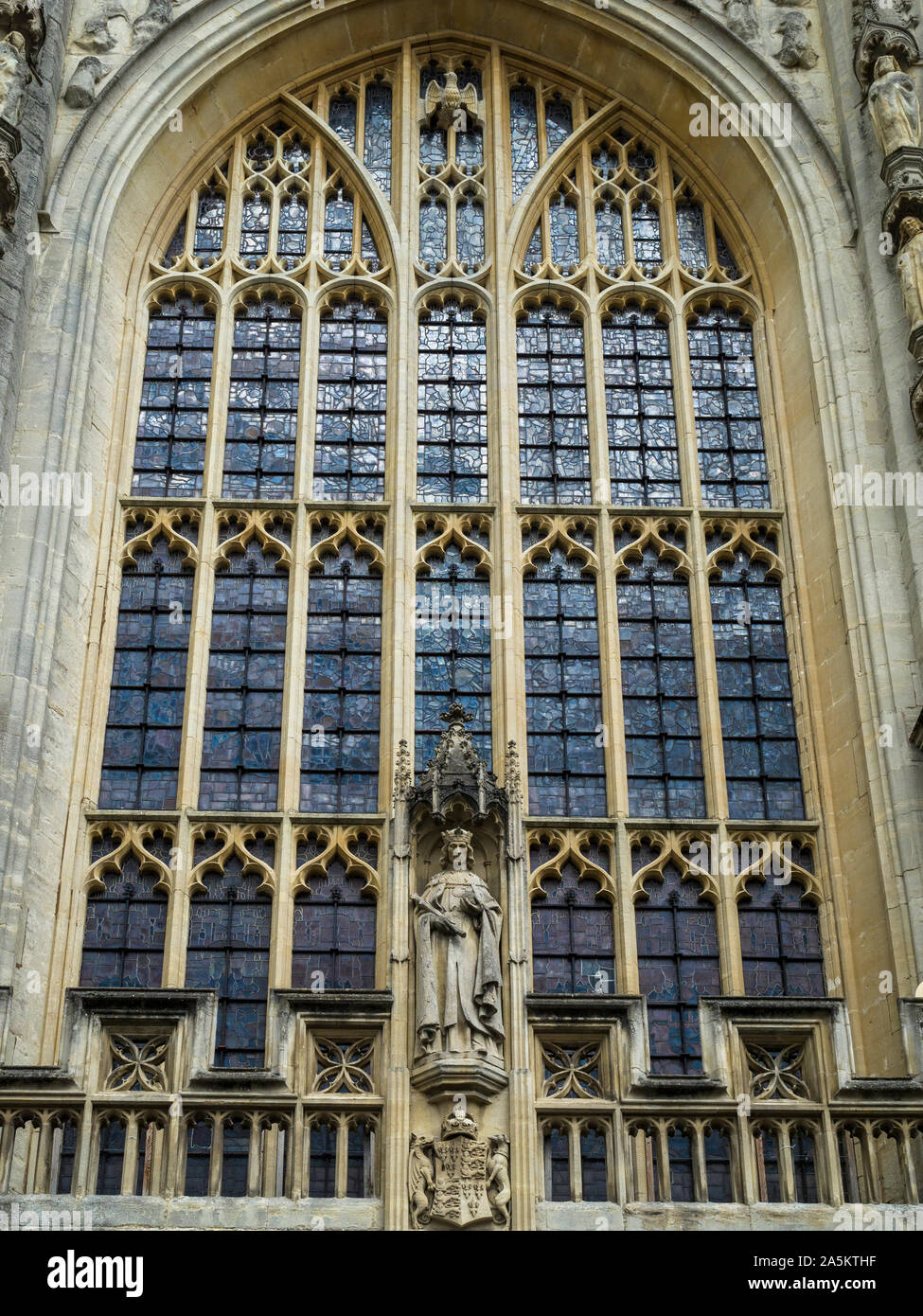 Large stain glass arch window exterior on the west front of Bath Abbey ...