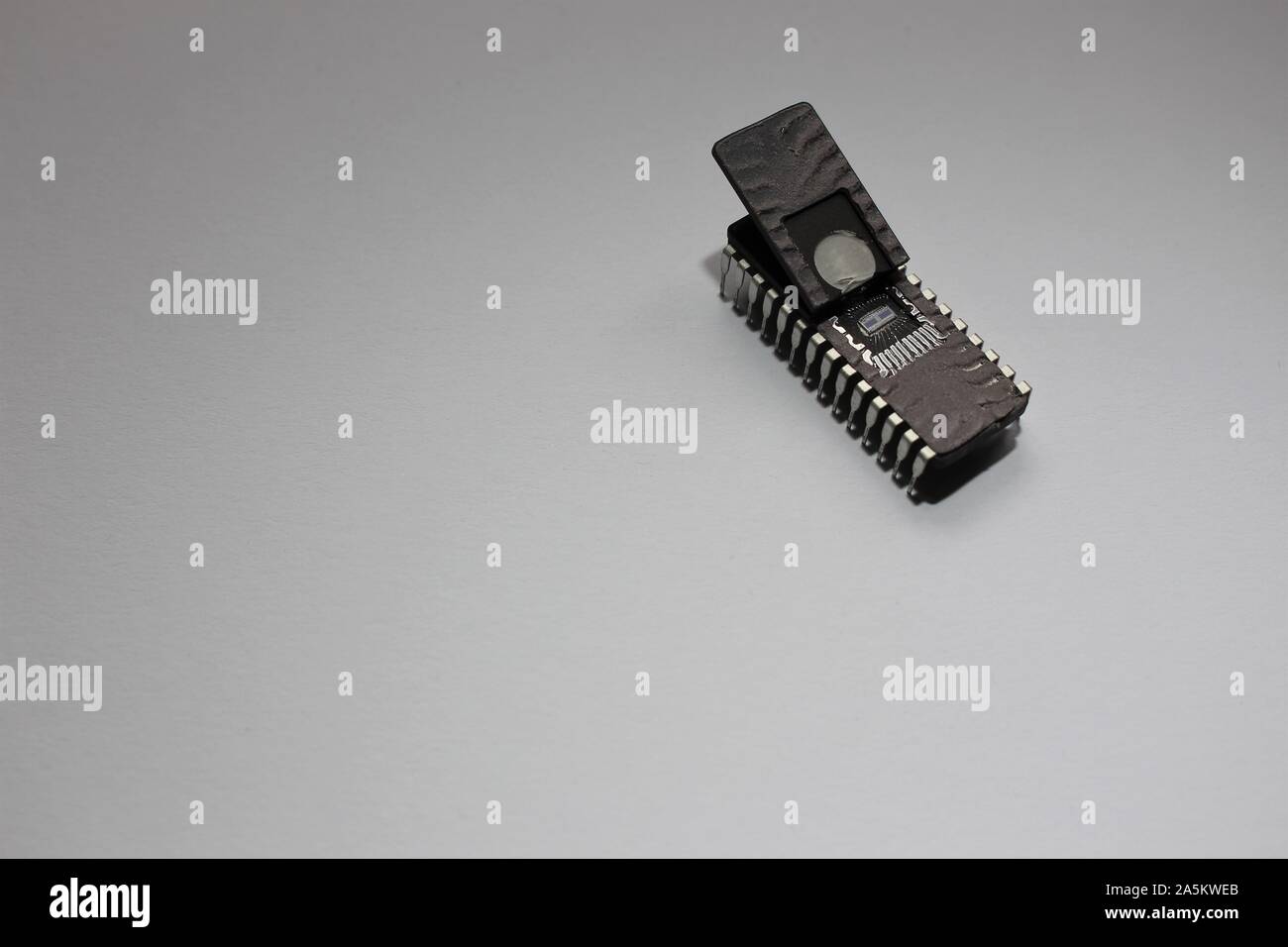 Open integrated circuit laying isolated on a piece of white paper and ...