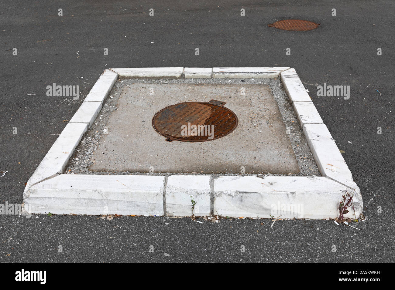 Sewer Manhole With Frame Protection at Pavement Stock Photo - Alamy