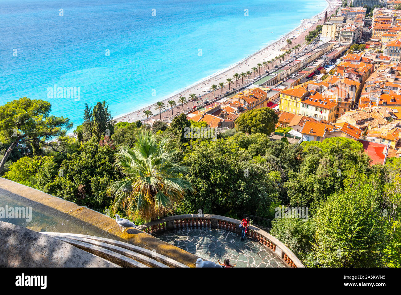 A female tourist on Castle Hill relaxes on a deck under the waterfall ...