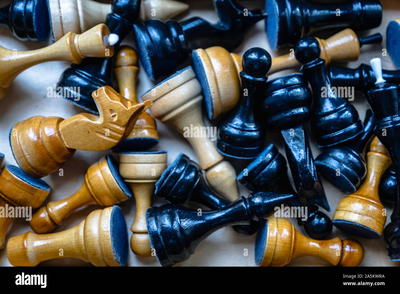 chess pieces scattered around, top down view. Randomly placed black and ...