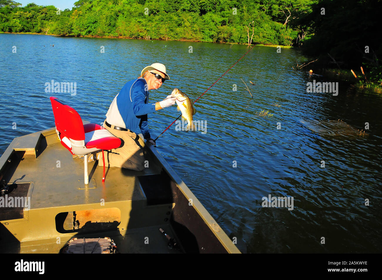 An angler battles a strong largemouth bass in Mexican bass waters ...