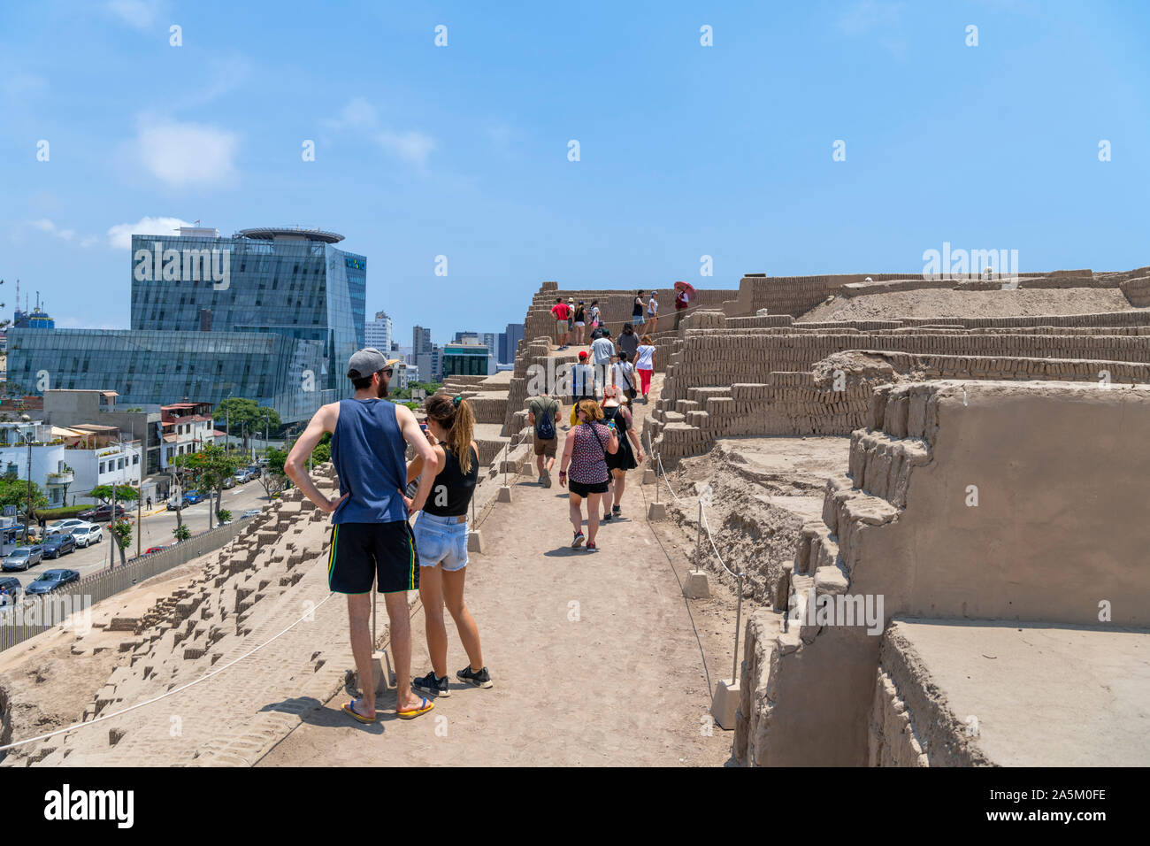 Visitors on a guided tour of the ruins of Huaca Pucllana, an adobe ...