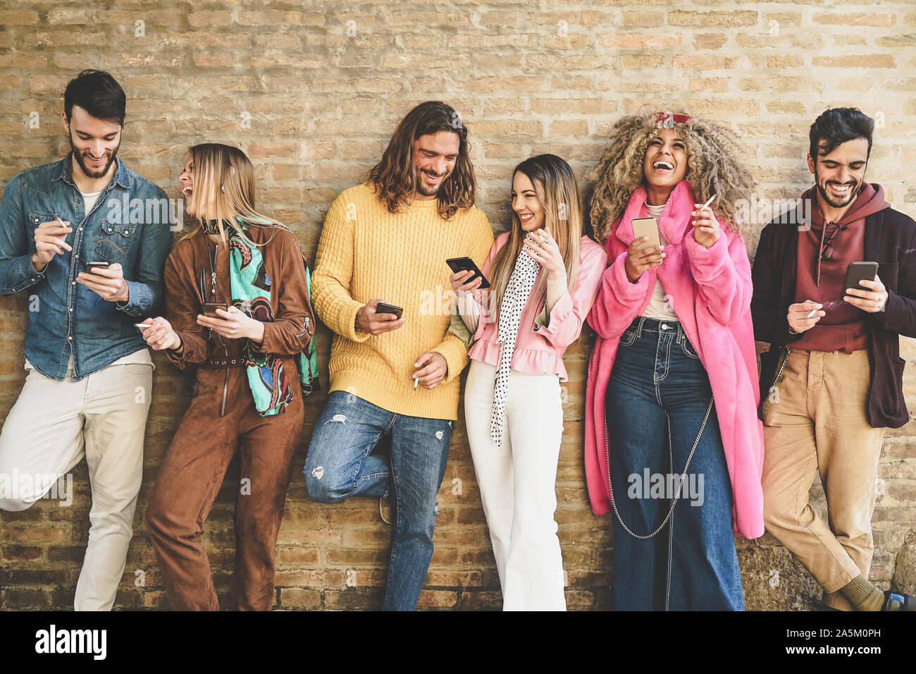 Group of friends using mobile phones outdoor - Young happy people ...