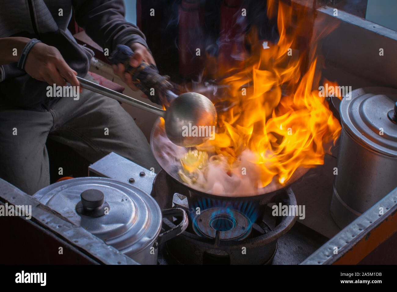 Cooking flame on the top of a wok Stock Photo - Alamy