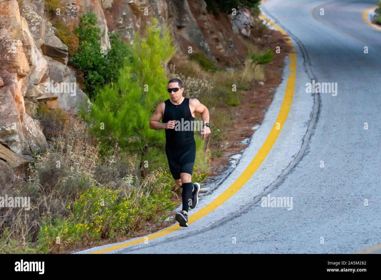 male athlete runner while running in the mountain road Stock Photo - Alamy