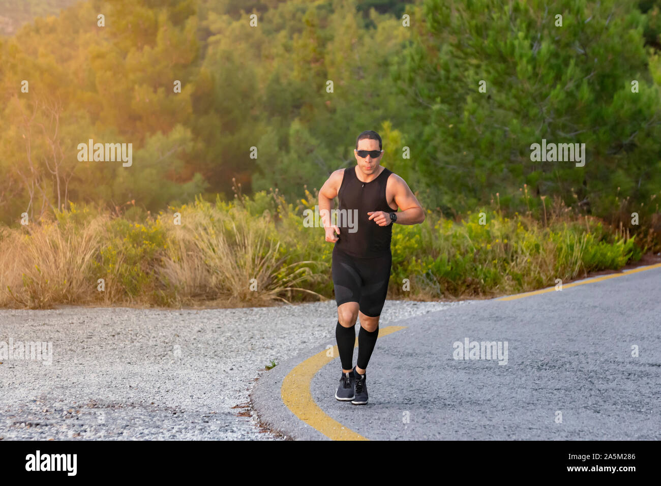 male athlete runner while running in the mountain road Stock Photo - Alamy