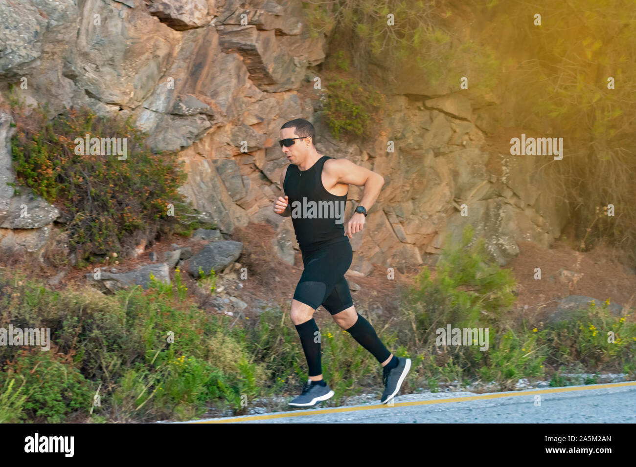 male athlete runner while running in the mountain road Stock Photo - Alamy