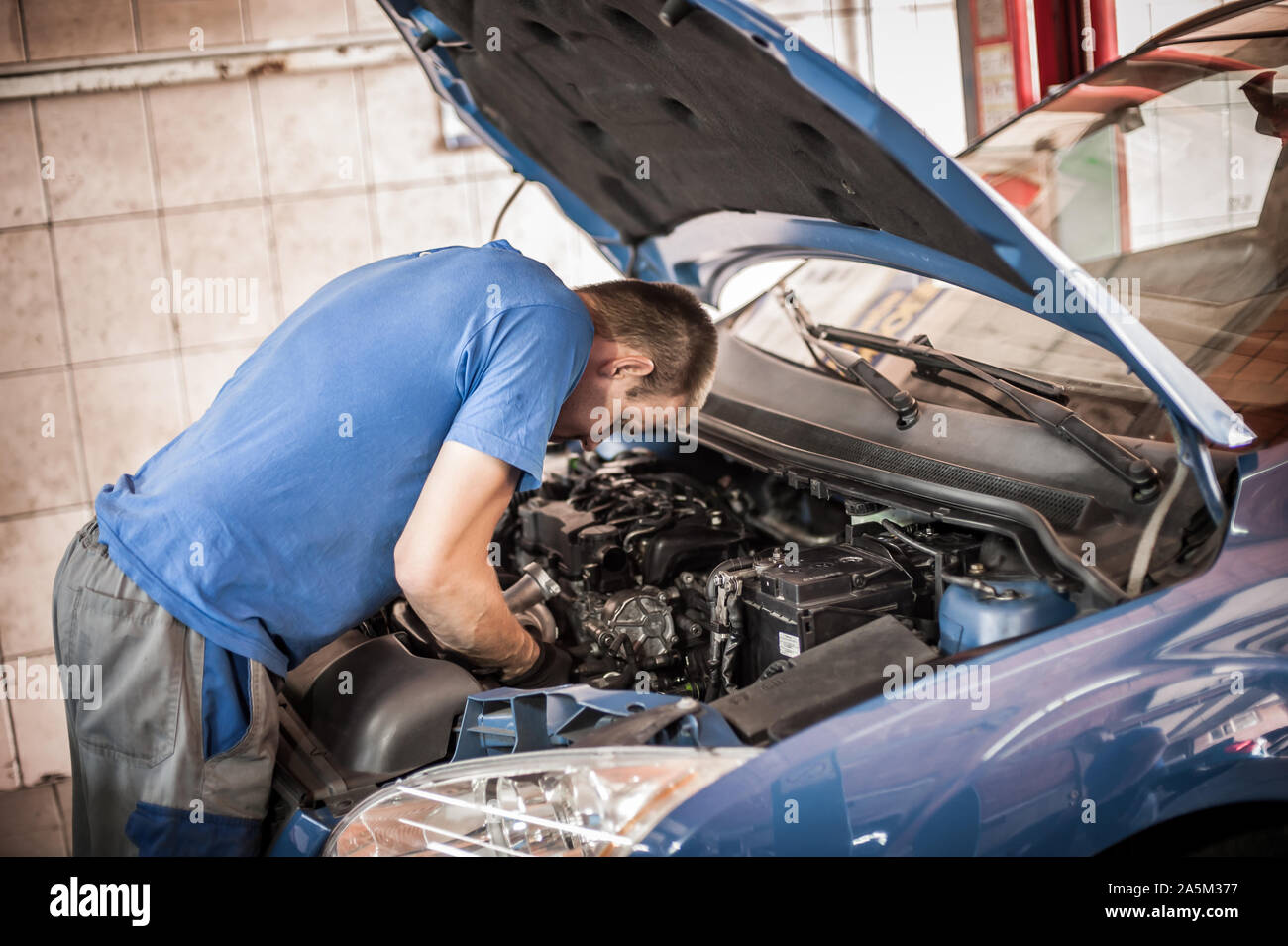 Car master auto mechanic repairer service technician checks and repairs ...