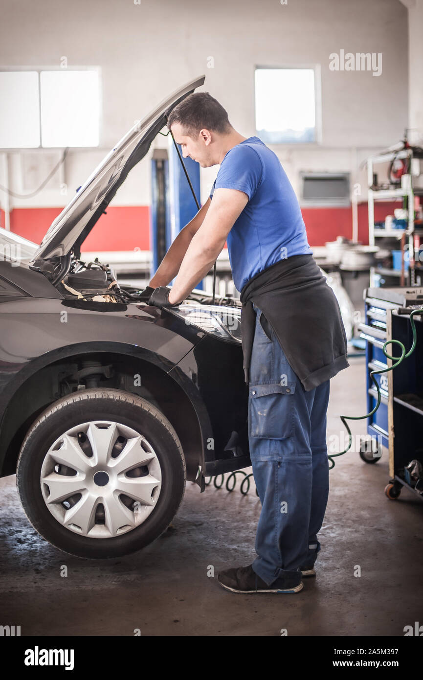 Car master auto mechanic repairer service technician checks and repairs ...