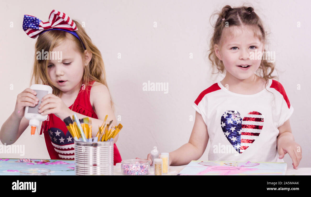 Little girls dress in patriotic red, white, and blue clothes creating ...