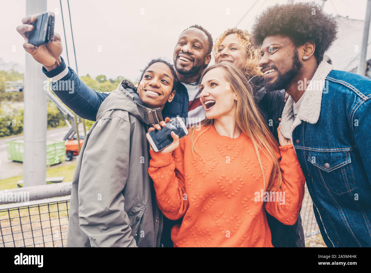 Friends making the best of rain and bad weather Stock Photo - Alamy