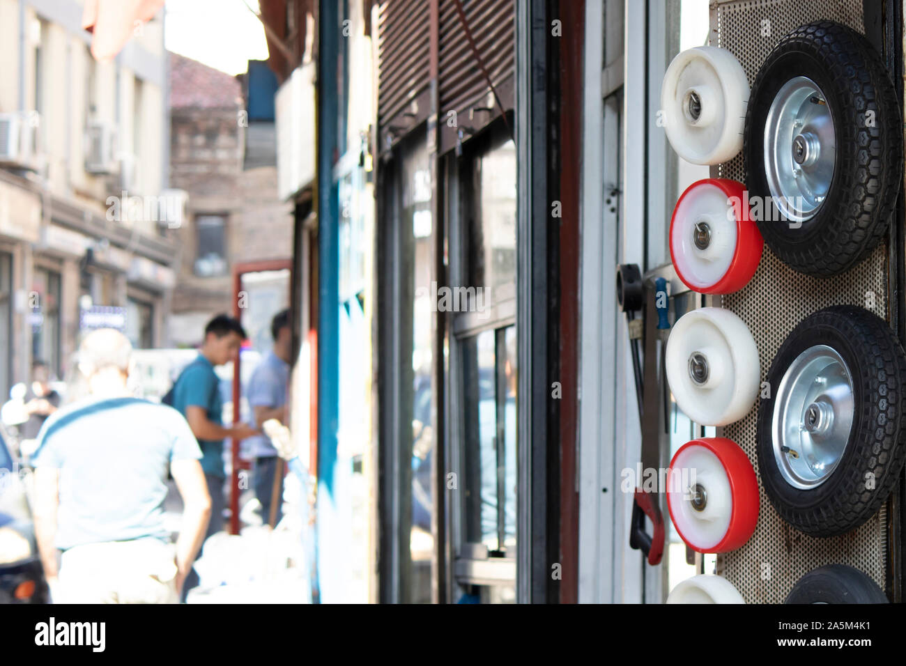Small wheelbarrow wheels hanging for sale in front of store Stock Photo ...