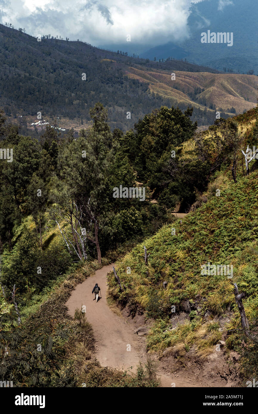 One man walking on the road in mountain Stock Photo - Alamy
