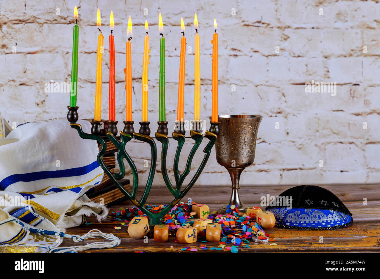 Lighting candles in menorah for Hanukkah in the Jewish Festival Stock ...