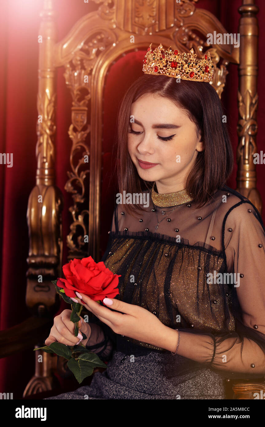 Close up portrait of queen sitting on throne with flower Stock Photo ...