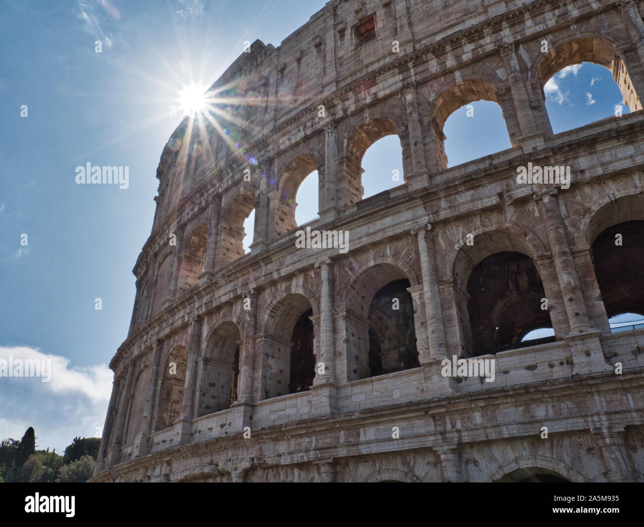 The Coloseum of Rome- with a nice sunstar Stock Photo - Alamy