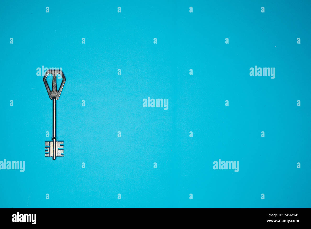Key on blue background. Minimal creative style Stock Photo - Alamy