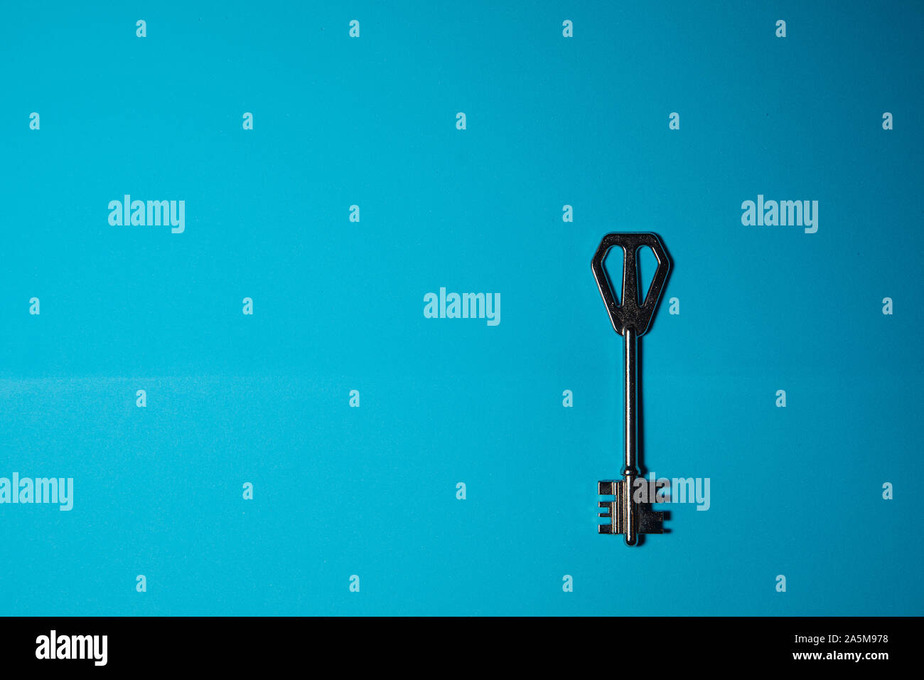 Key on blue background. Minimal creative style Stock Photo - Alamy