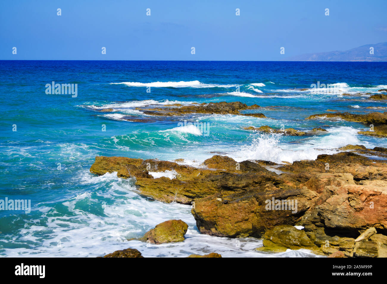 Sea wave breaks on beach rocks in Crete, Greece Stock Photo - Alamy