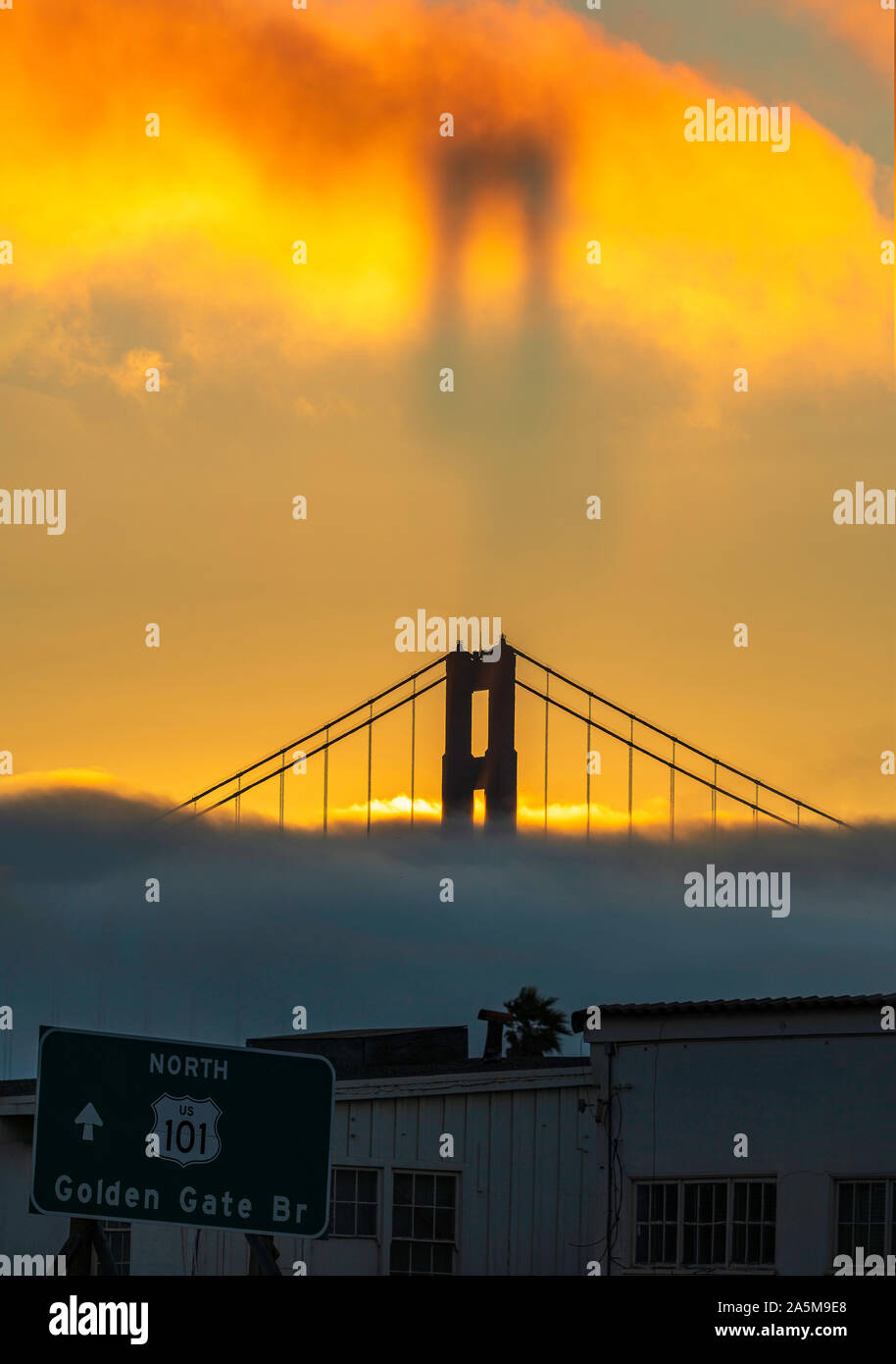 Golden Gate Bridge Sunset with Shadow of Bridge in Clouds and Road Sign ...