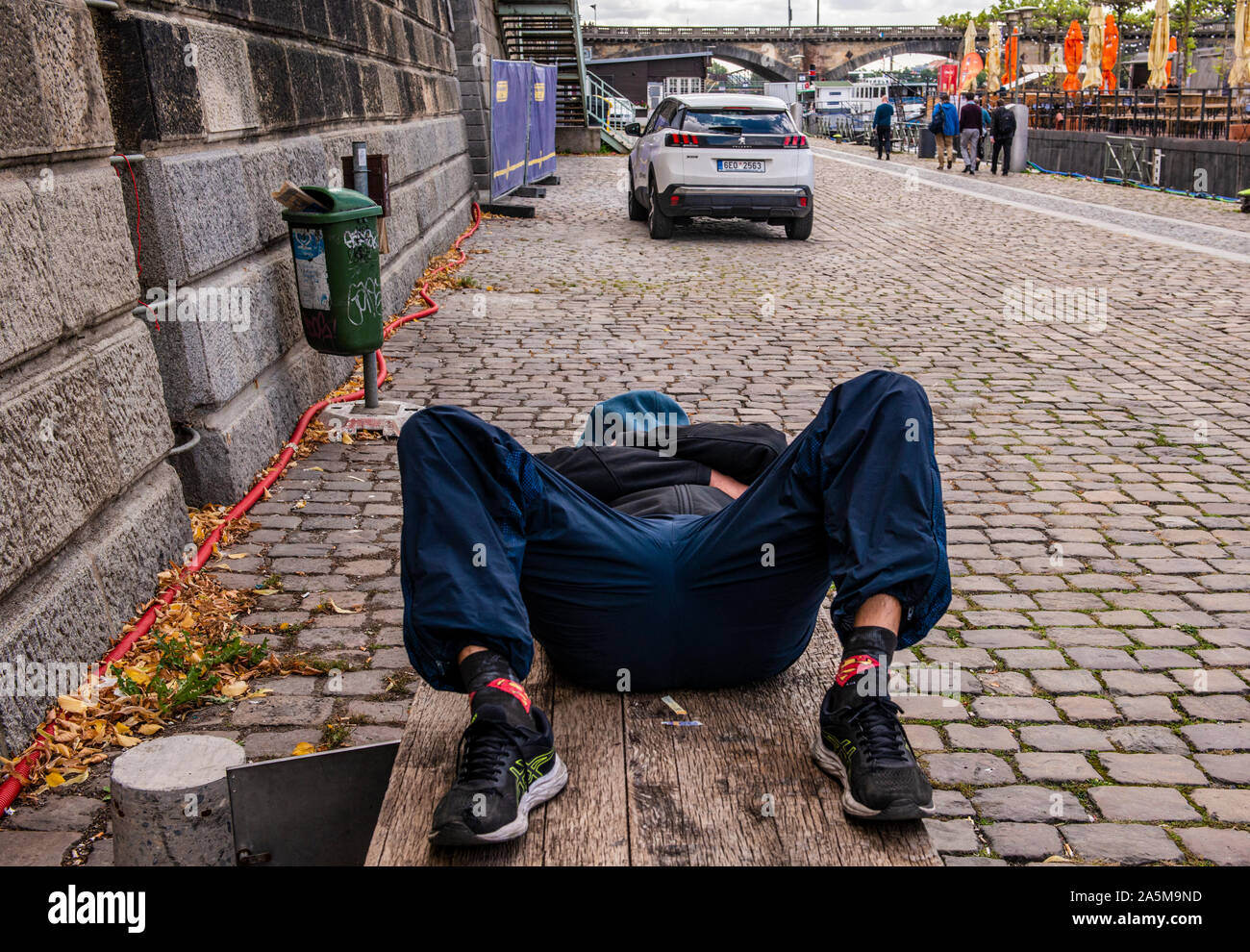 Homeless man sleeping on wooden bench, Prague, Czech Republic Stock ...