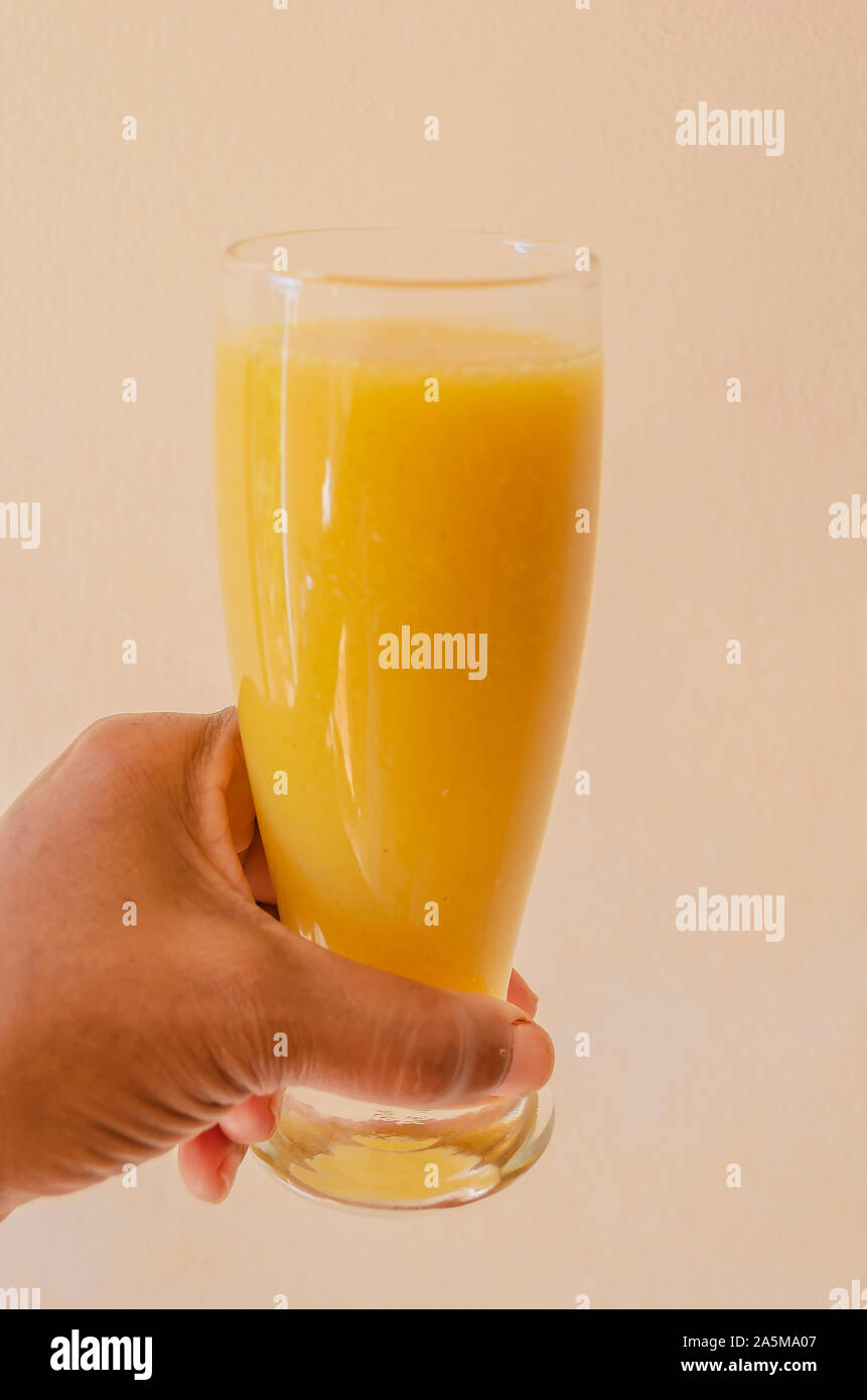 Holding a Glass Of June Plum Juice Stock Photo - Alamy