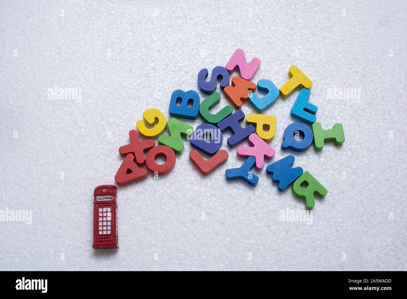 Red telephone booth model and colorful wooden letters Stock Photo - Alamy