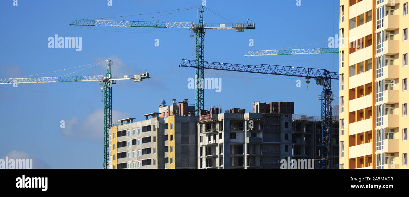 Construction Cranes And Modern Apartment Buildings Building