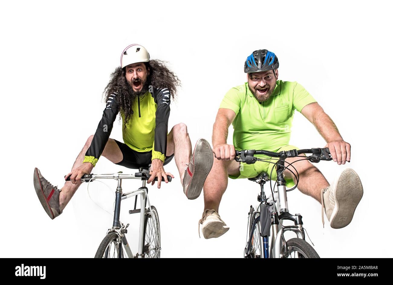 Two eccentric friends riding a bikes - team work Stock Photo - Alamy