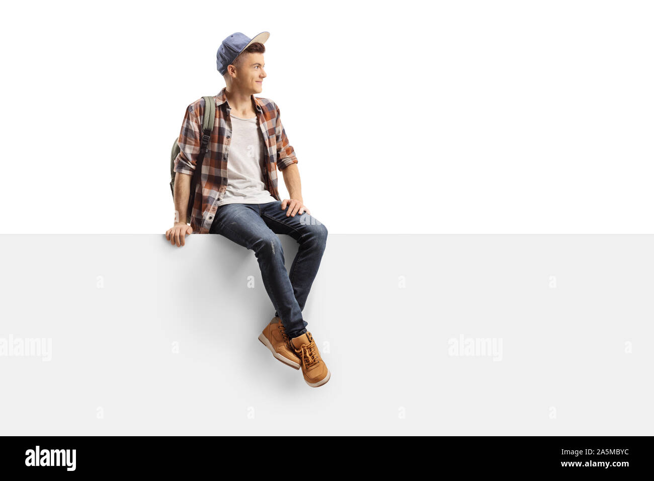 Male student sitting on a panel and looking to the side with a smiling ...