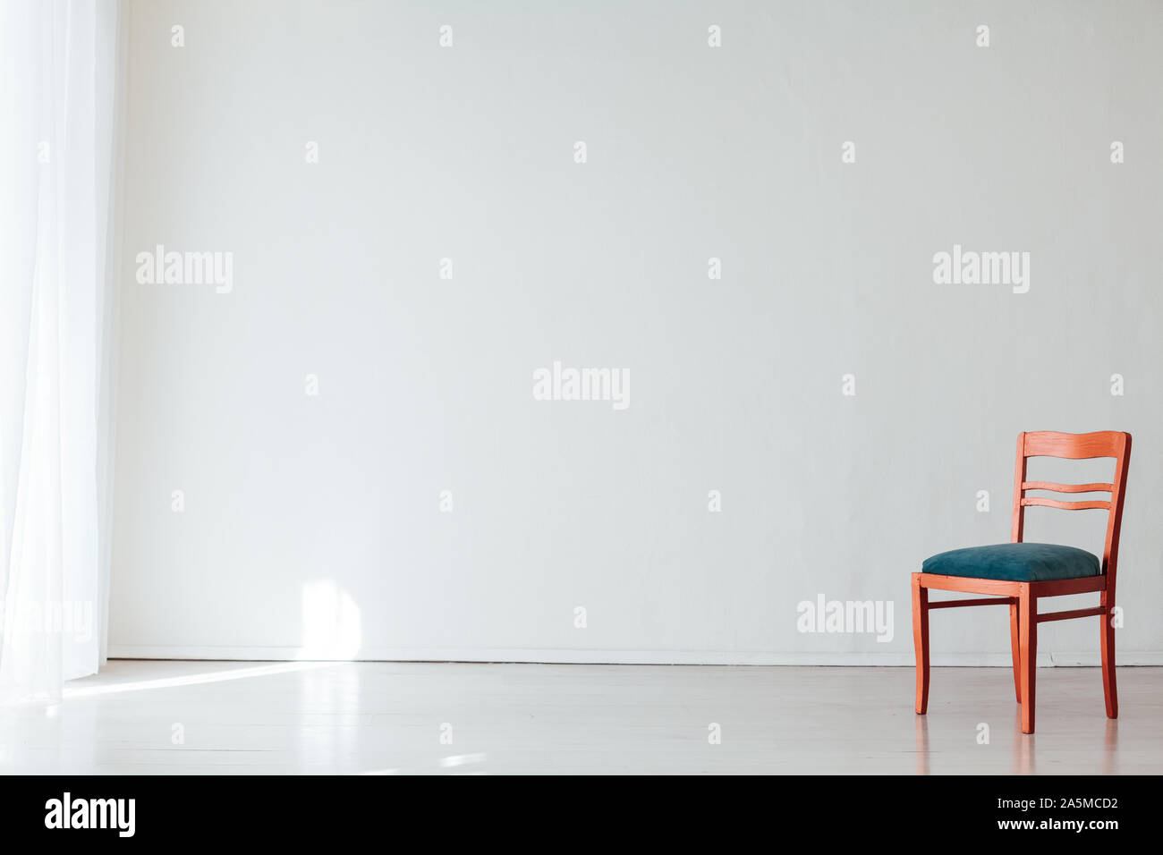 one chair in the interior of a white empty room Stock Photo - Alamy