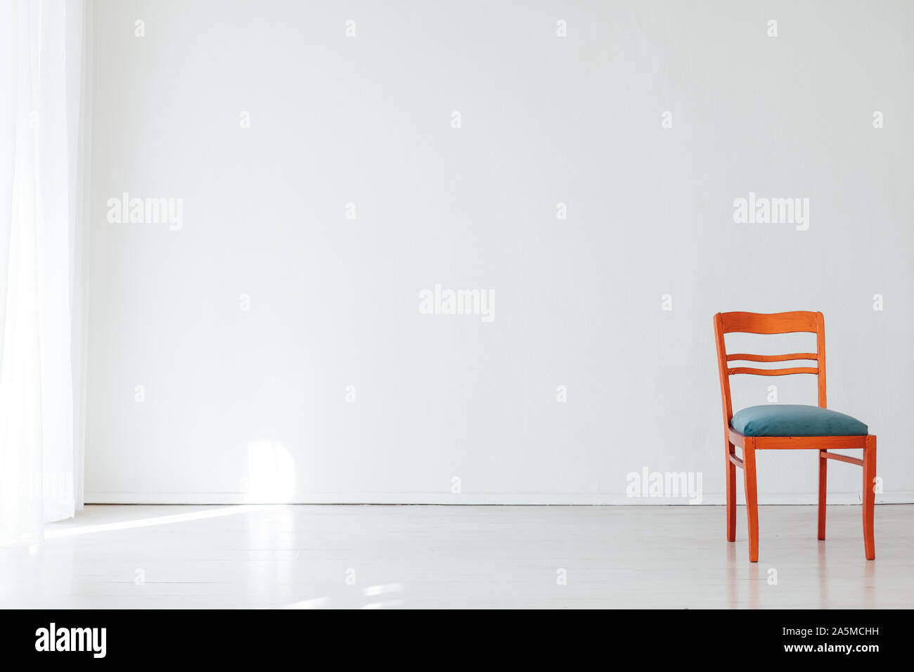 one chair in the interior of a white empty room Stock Photo - Alamy