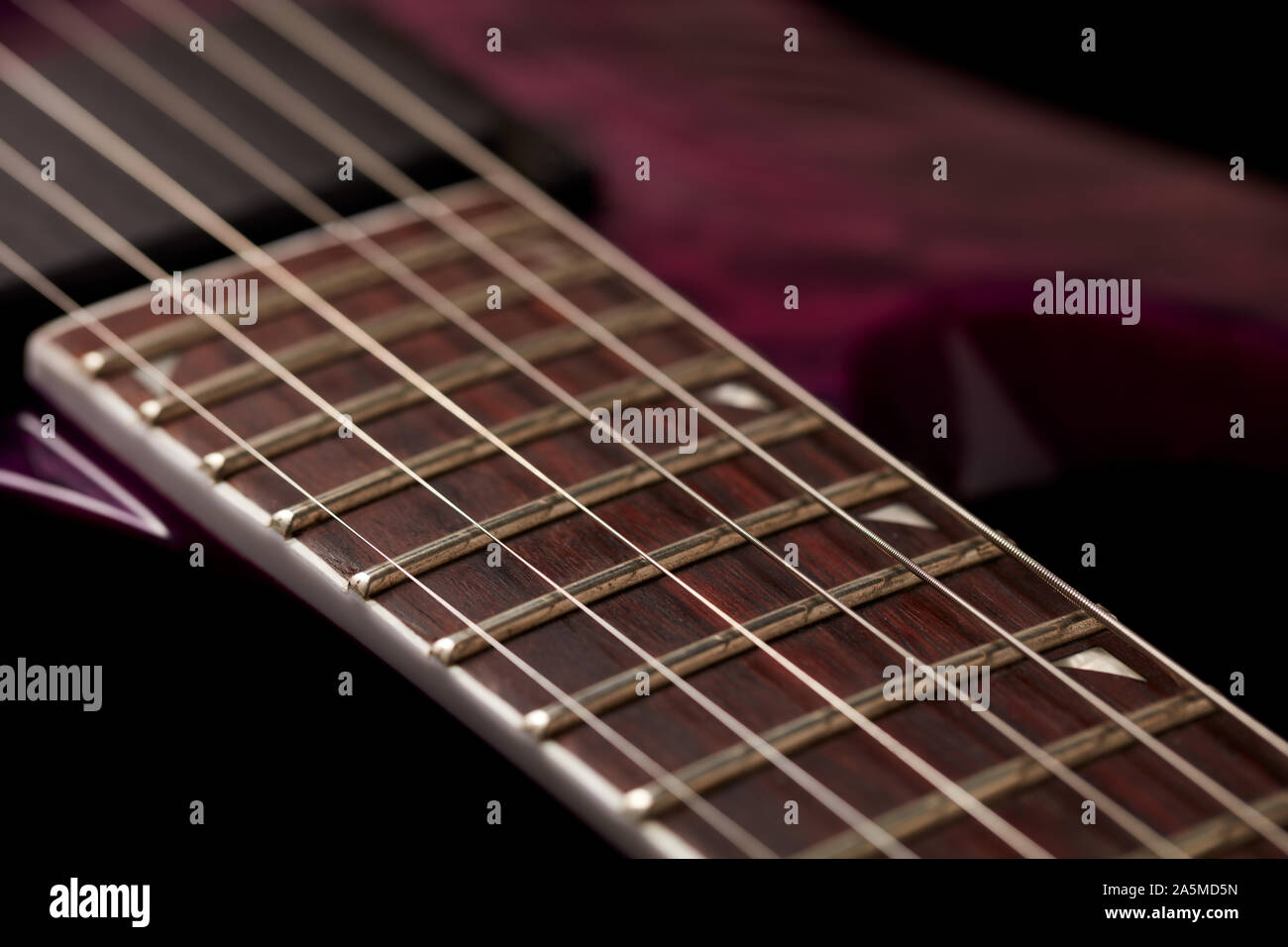 Fretboard of modern electric guitar on black background Stock Photo - Alamy