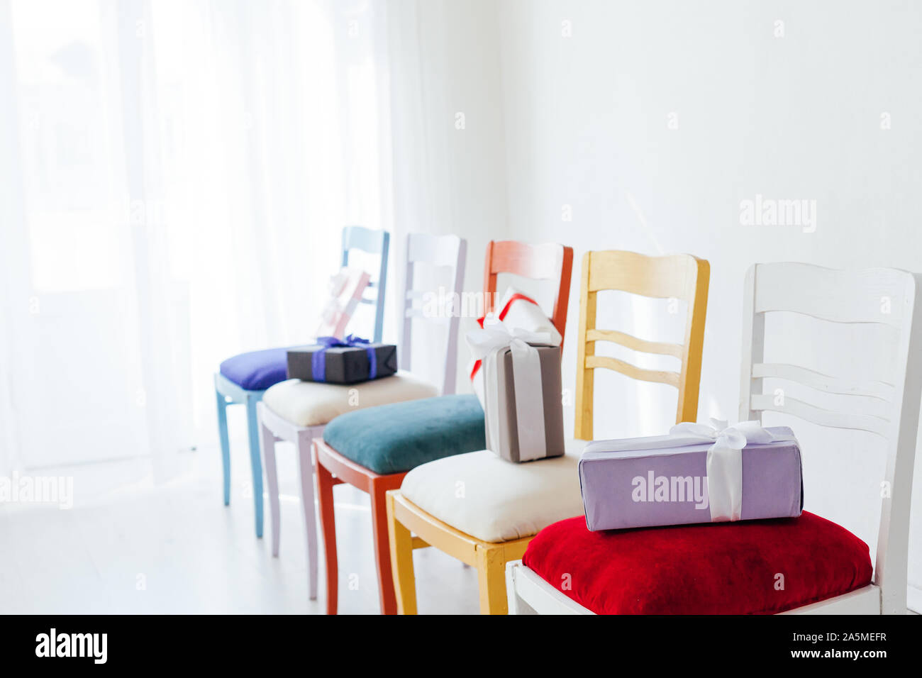 chairs with gifts in the interior of an empty white room Stock Photo ...