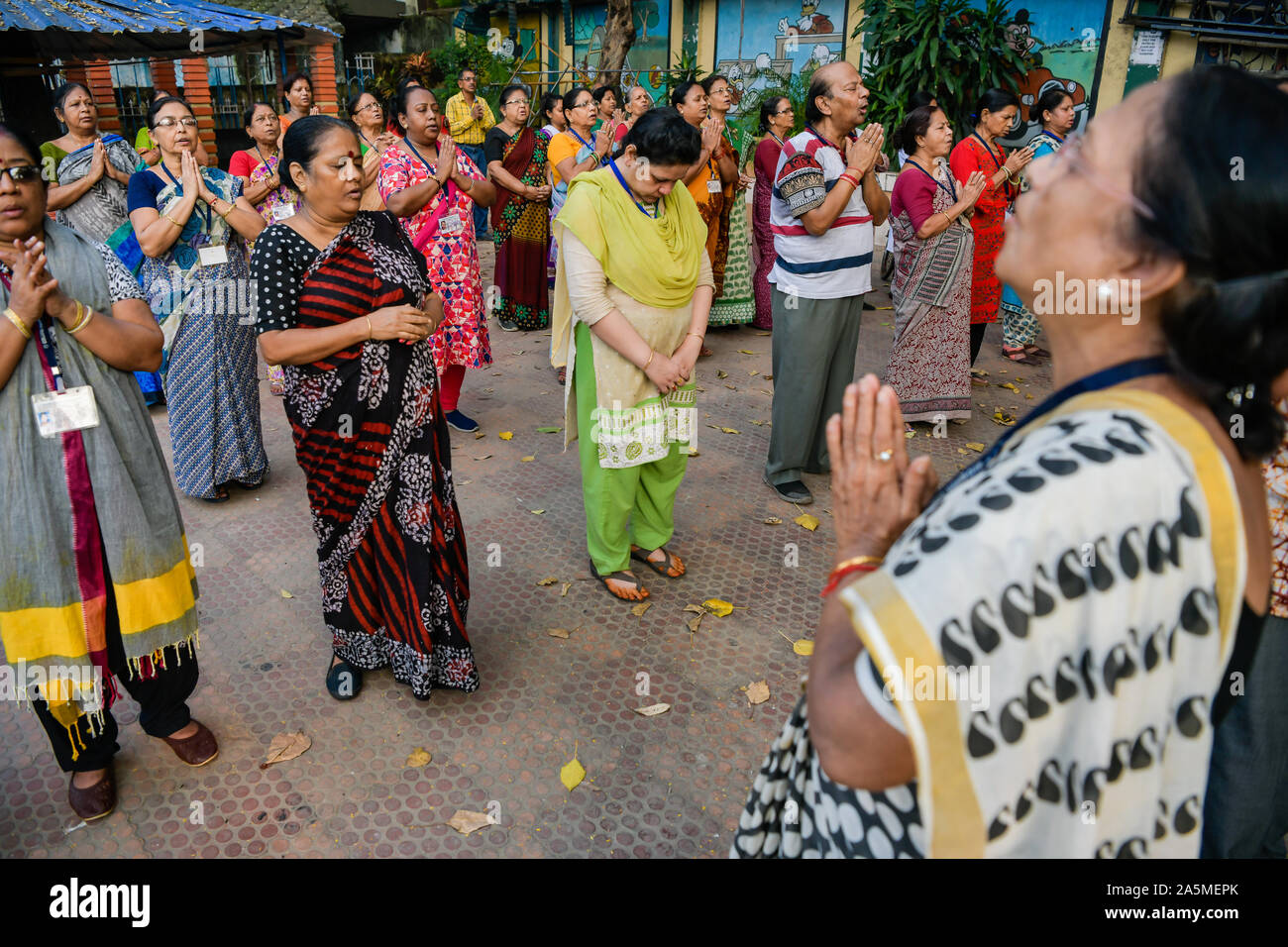 Senior People enjoy laughter yoga session at college square laughing ...