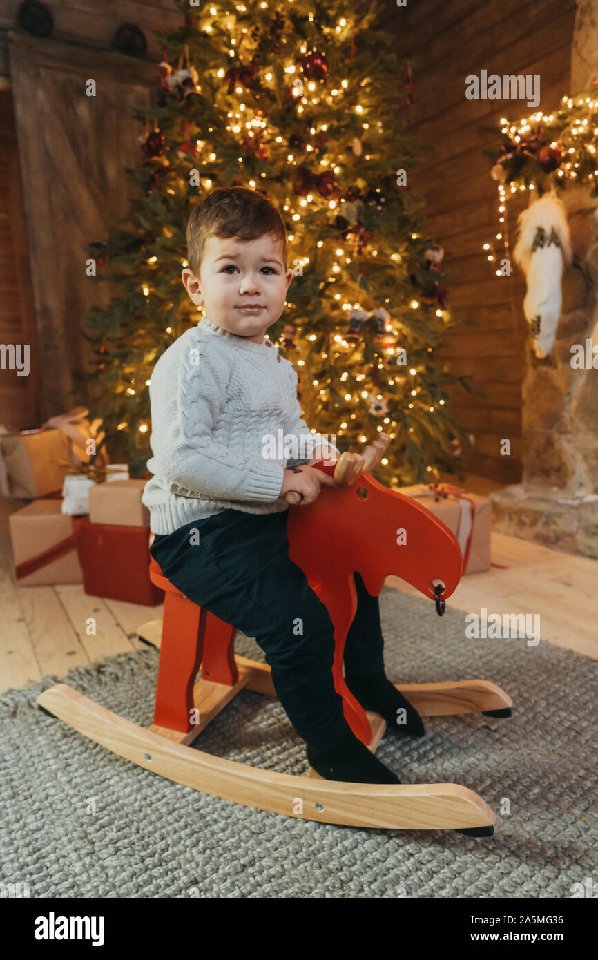 Shot of a cheerful kid riding on rocking horse Stock Photo - Alamy