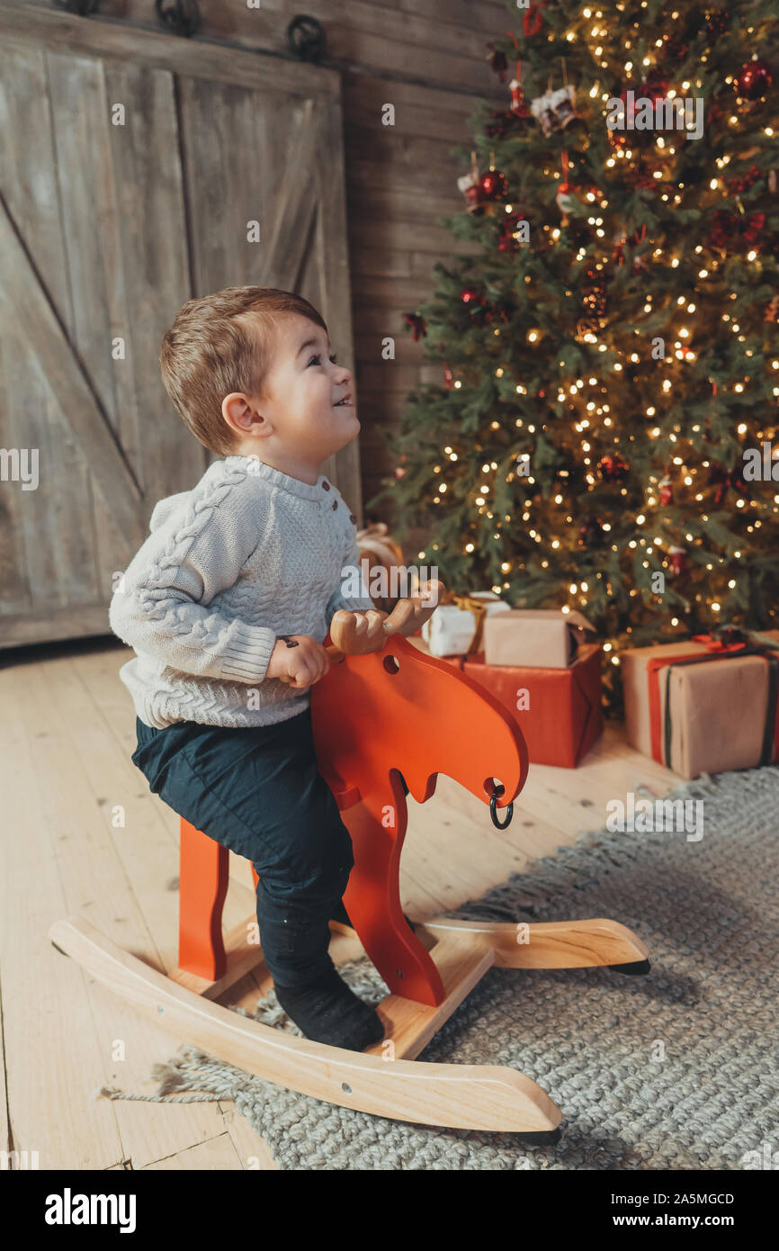 Shot of a cheerful kid riding on rocking horse Stock Photo - Alamy