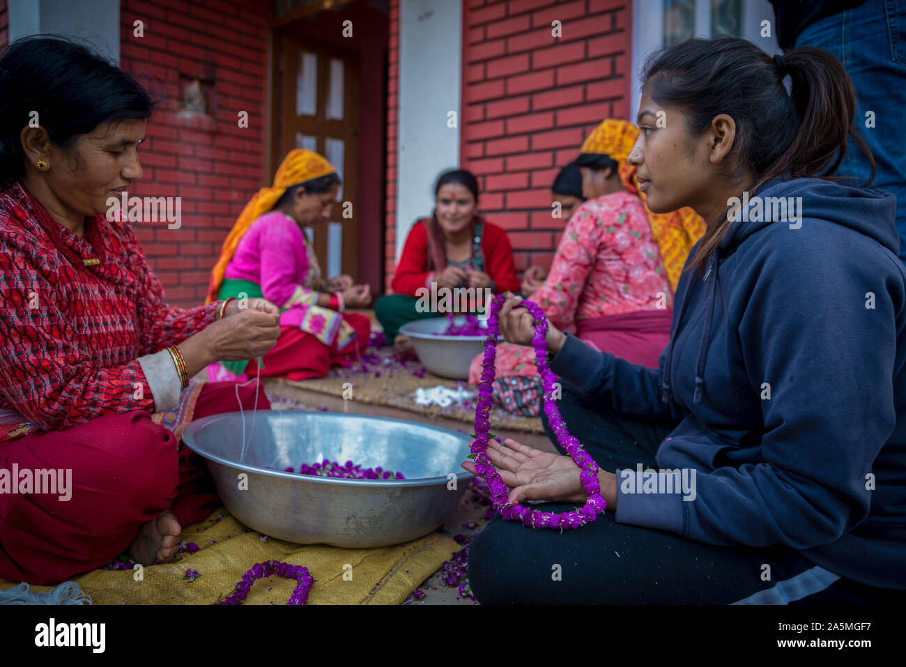 Nepalese women make garland from amaranth flowers for the upcoming ...