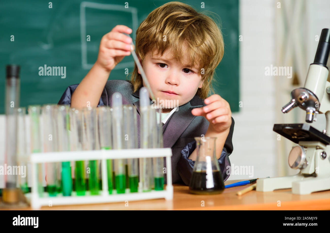 little boy at lesson. Back to school. Little kid learning chemistry in ...