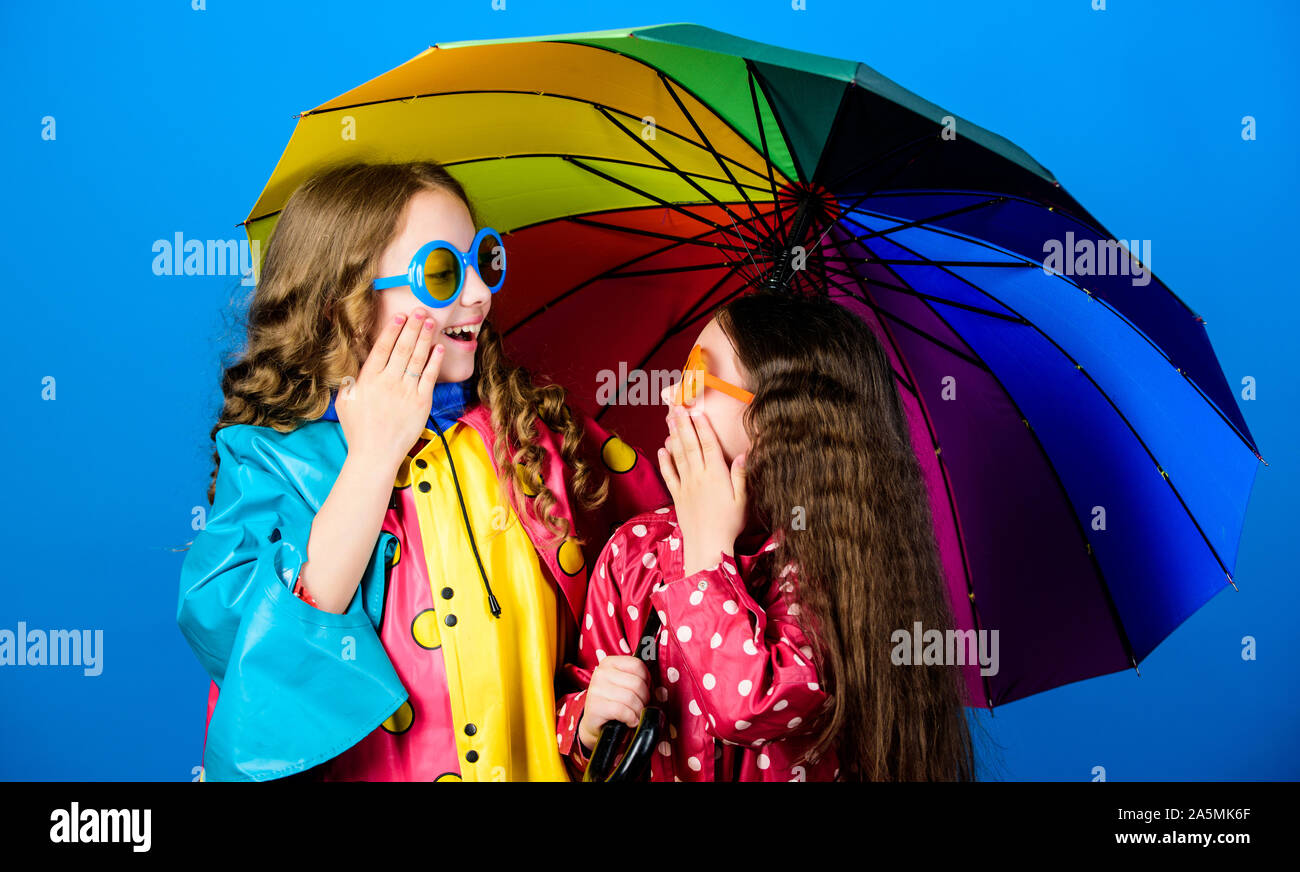 Children sharing umbrella hi-res stock photography and images - Alamy