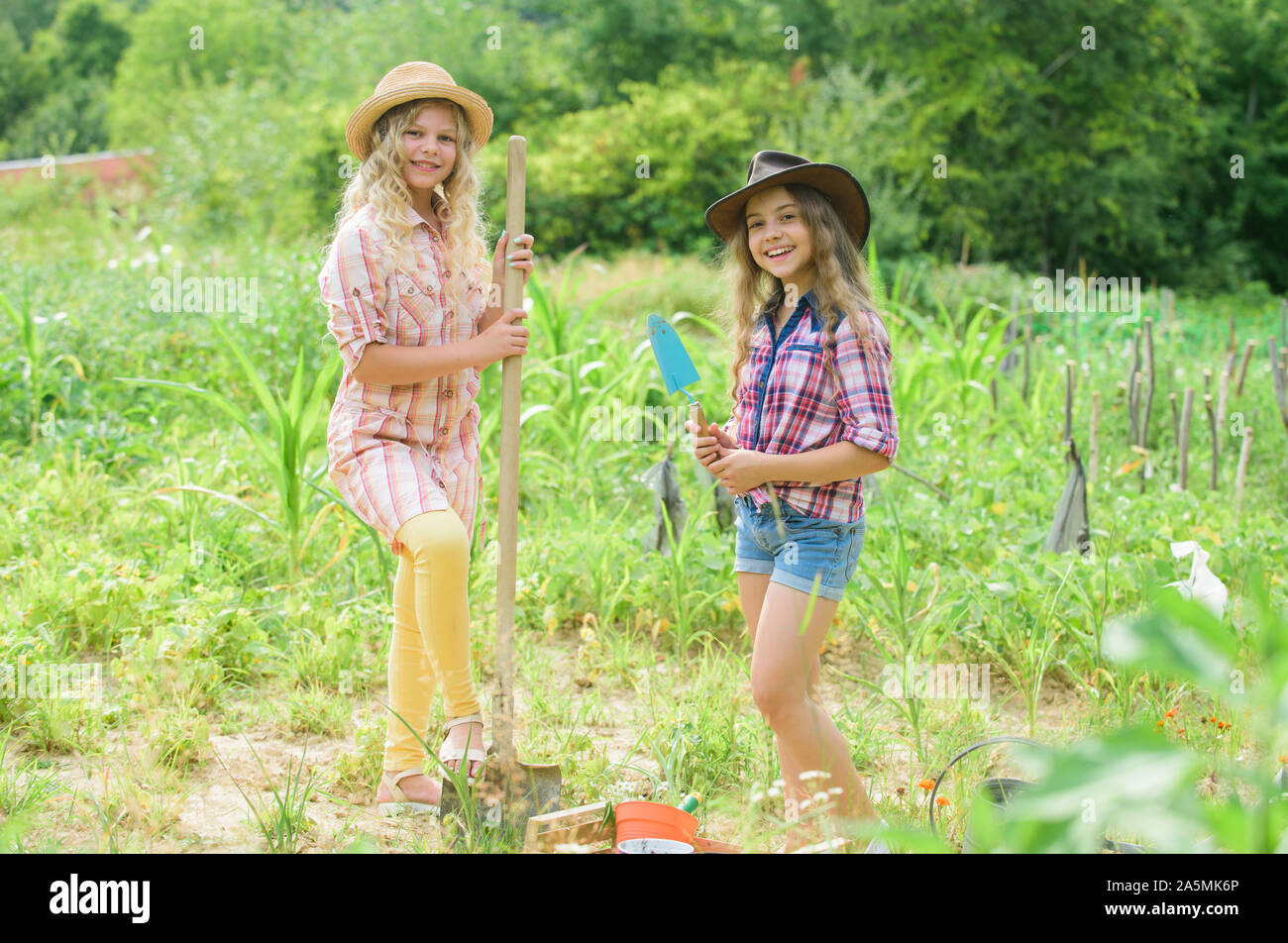 Made with love. small girls farmer in village garden. happy farming ...